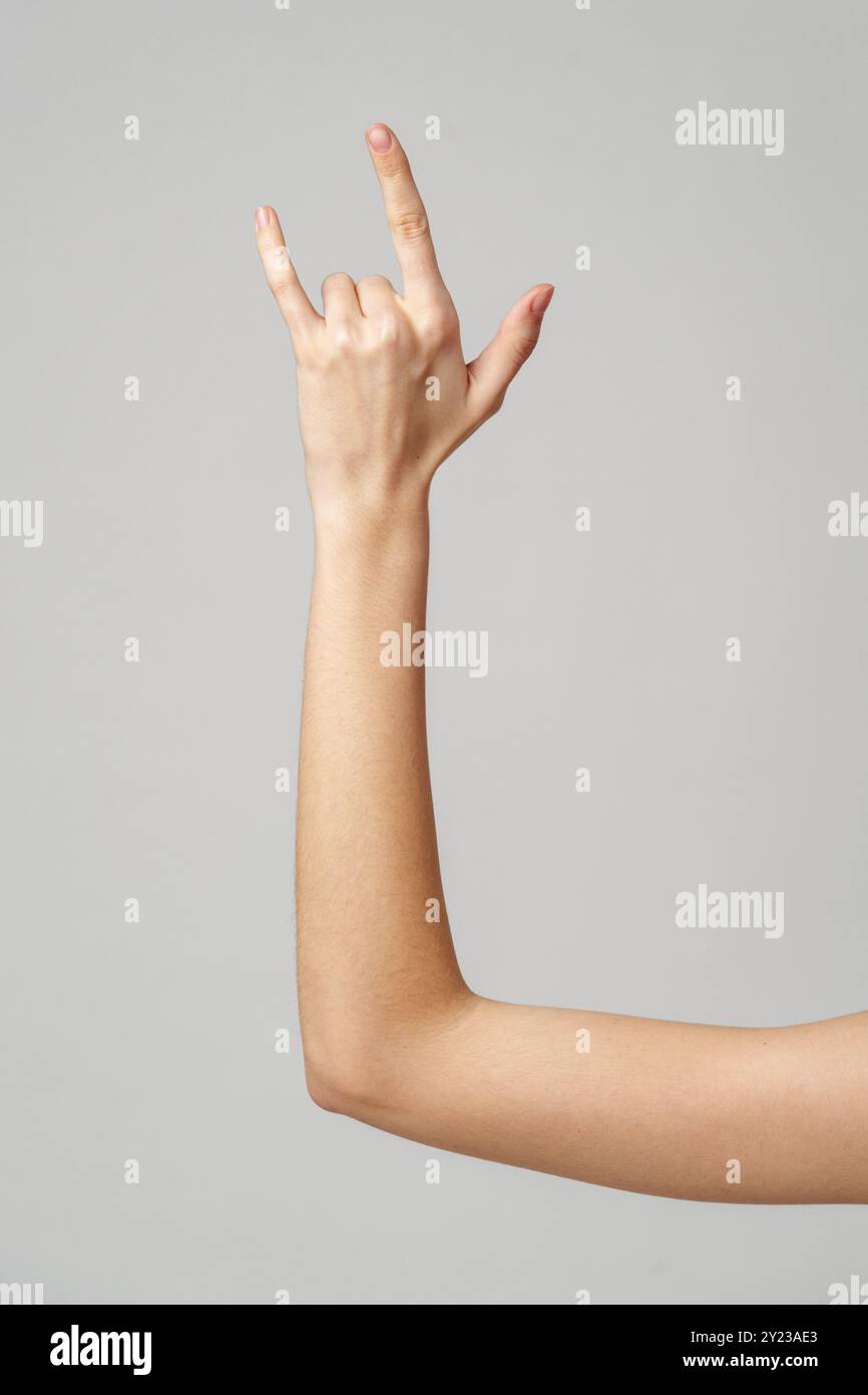 Woman making hand gesture rock hi-res stock photography and images - Alamy