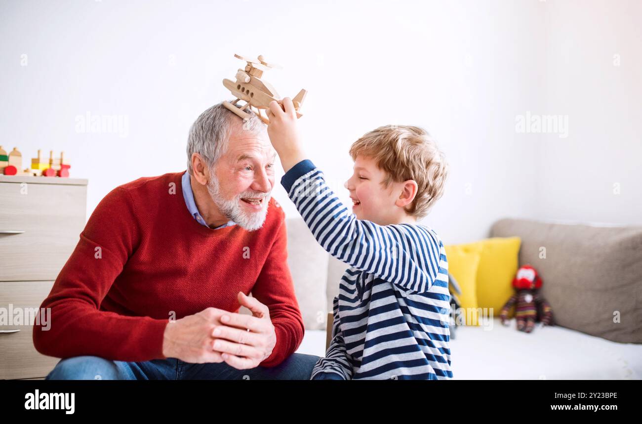 Grandpa grandson playing wooden toy hi-res stock photography and images ...