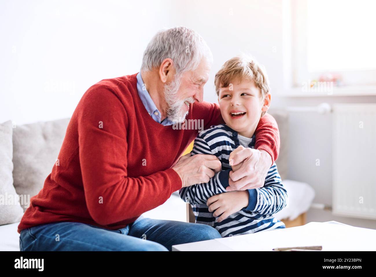 Grandfather spending time with grandson, taking care of him while ...