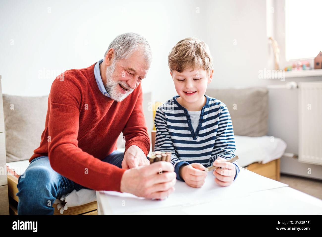 Grandfather spending time with grandson, taking care of him while ...