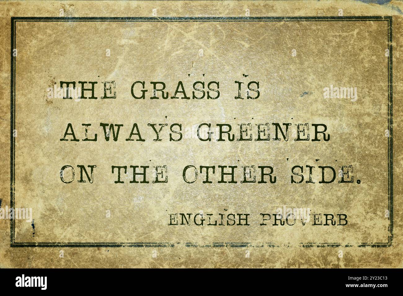 The grass is always greener on the other side - ancient English proverb printed on grunge ...