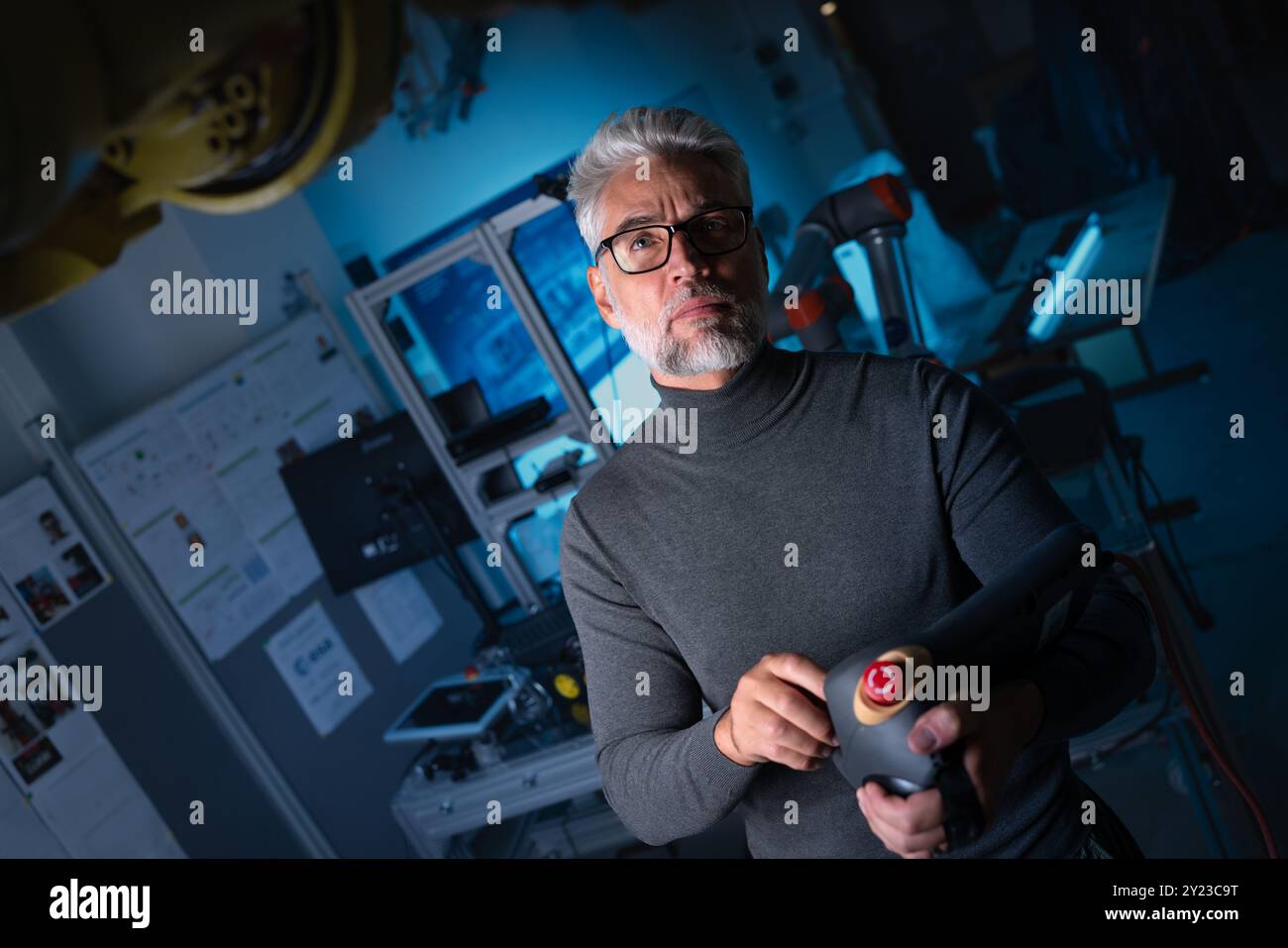 Automation engineer, technician holding remote controller of robotic ...