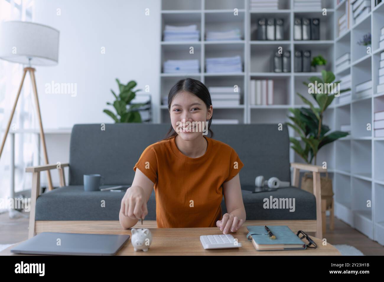 woman creates a detailed financial saving plan using a calculator to ...