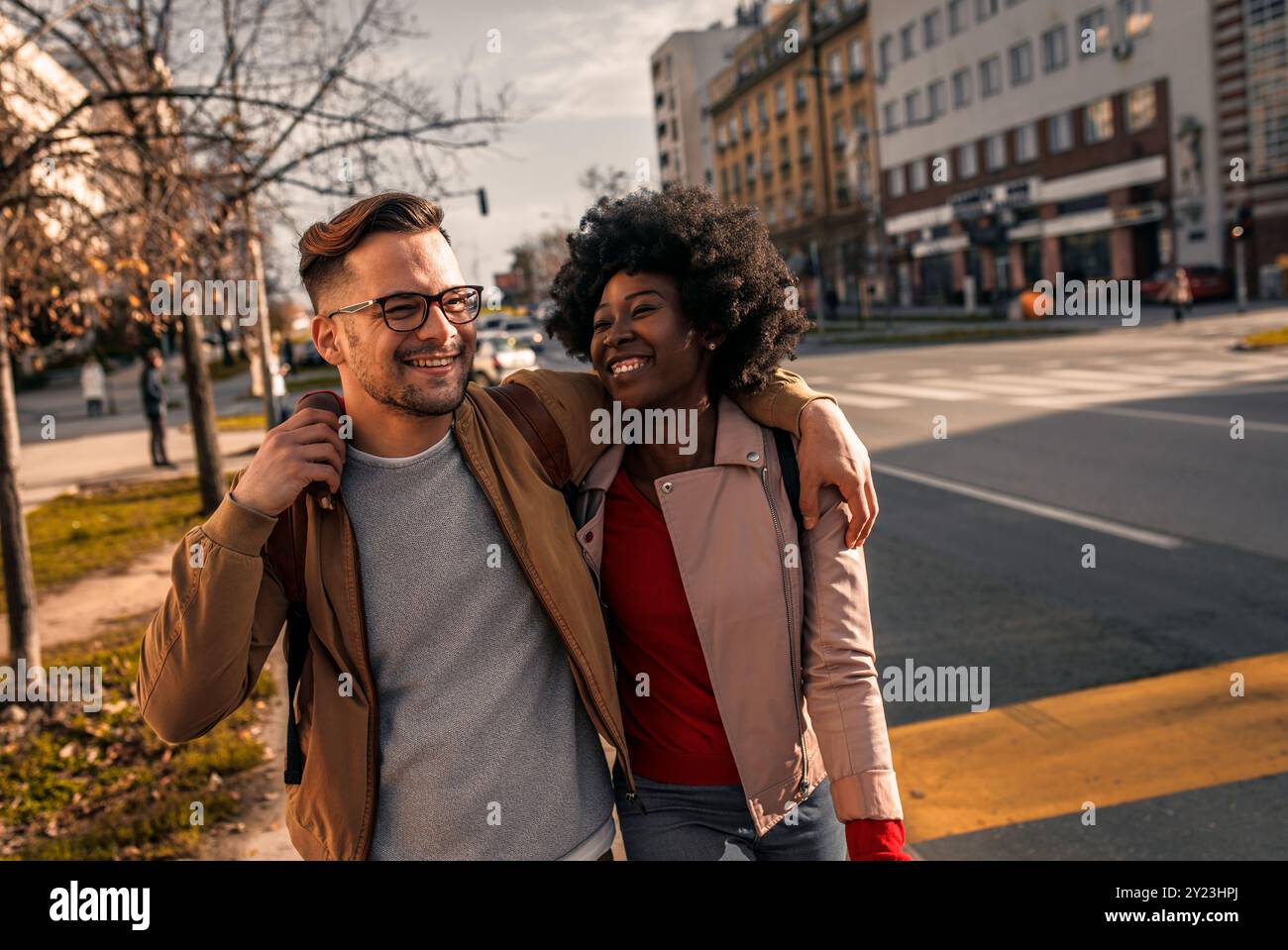 Smiling couple enjoying on vacation, young tourist having fun walking ...