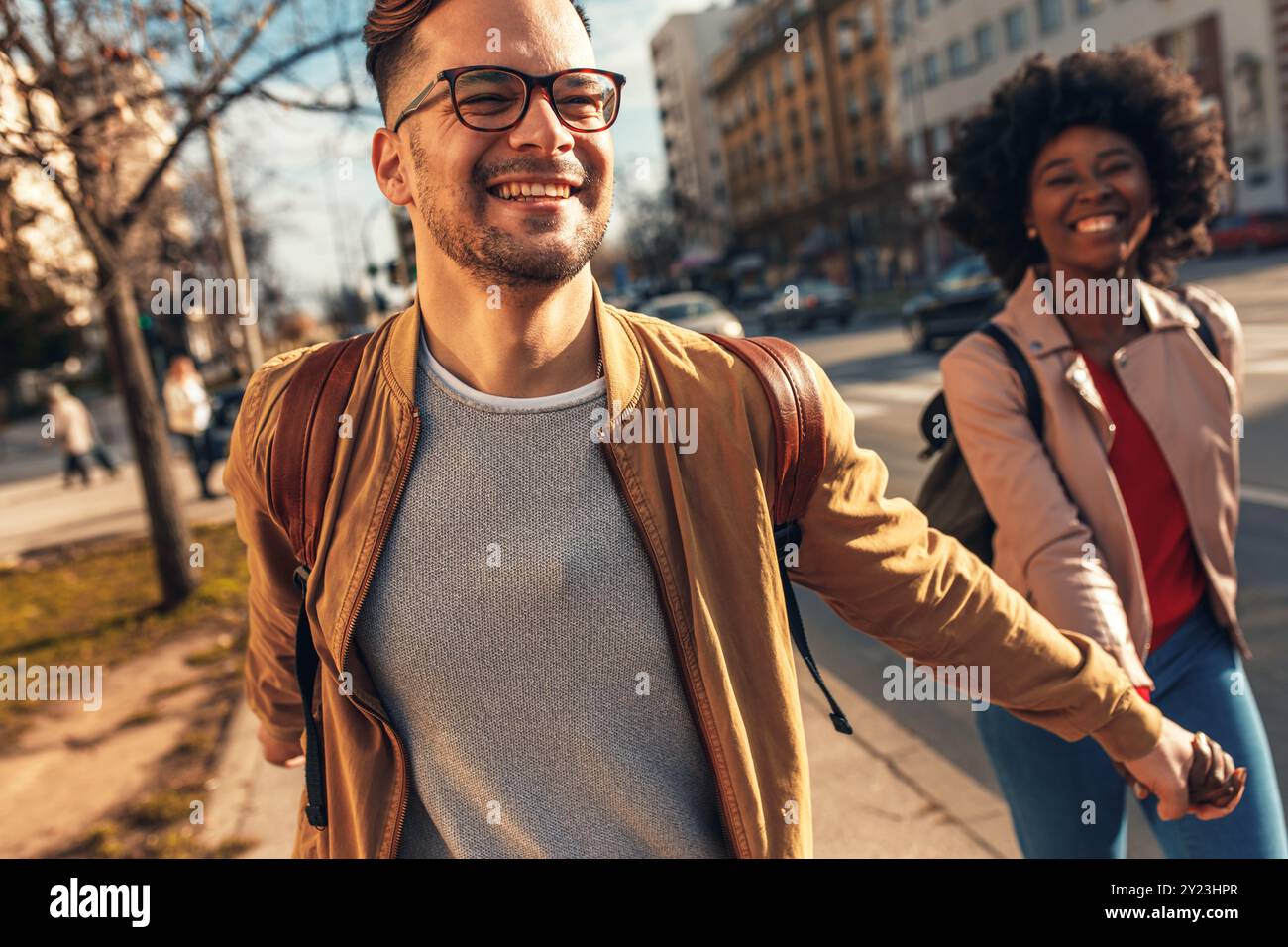 Smiling couple enjoying on vacation, young tourist having fun walking ...