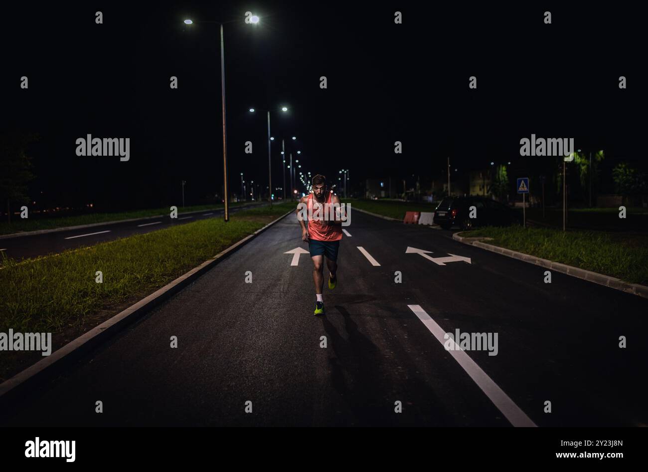 Man running through the city street at night Stock Photo - Alamy