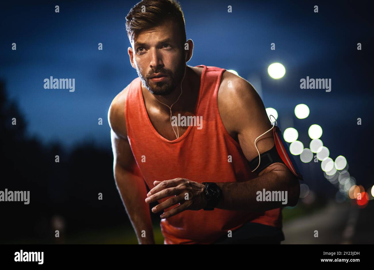 Man running through the city street at night Stock Photo - Alamy