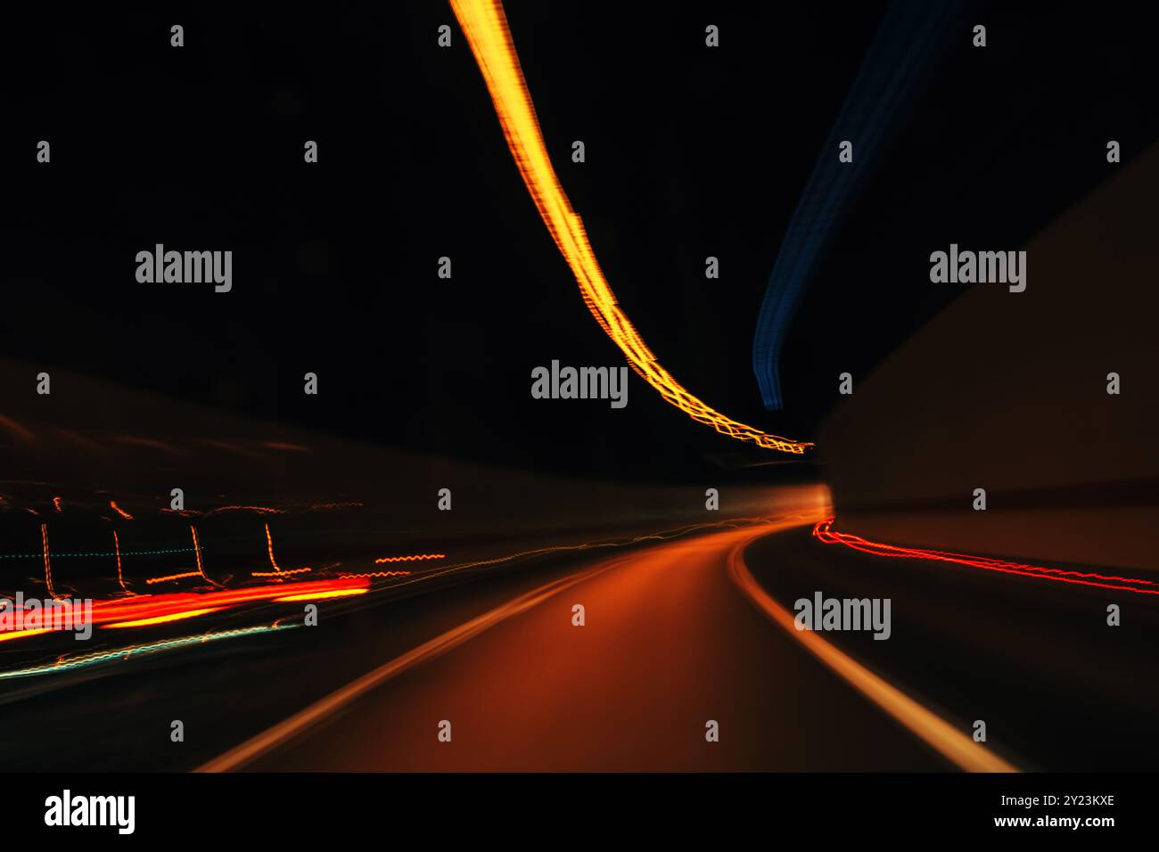 Long exposure photo of car driving through highway tunnel as abstract ...