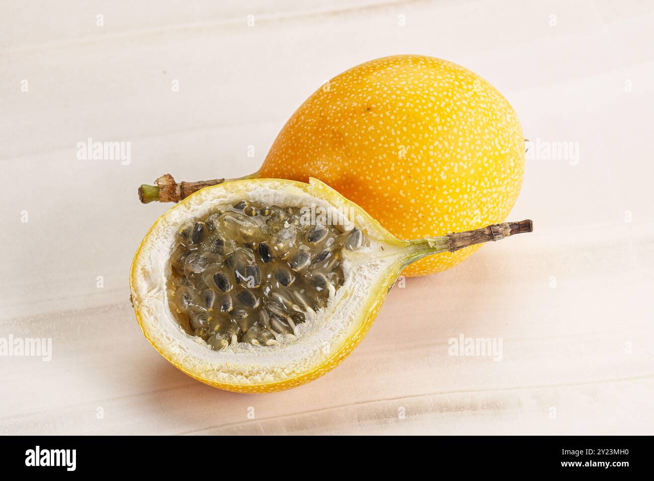 Yellow granadilla fruit with cut half Stock Photo - Alamy