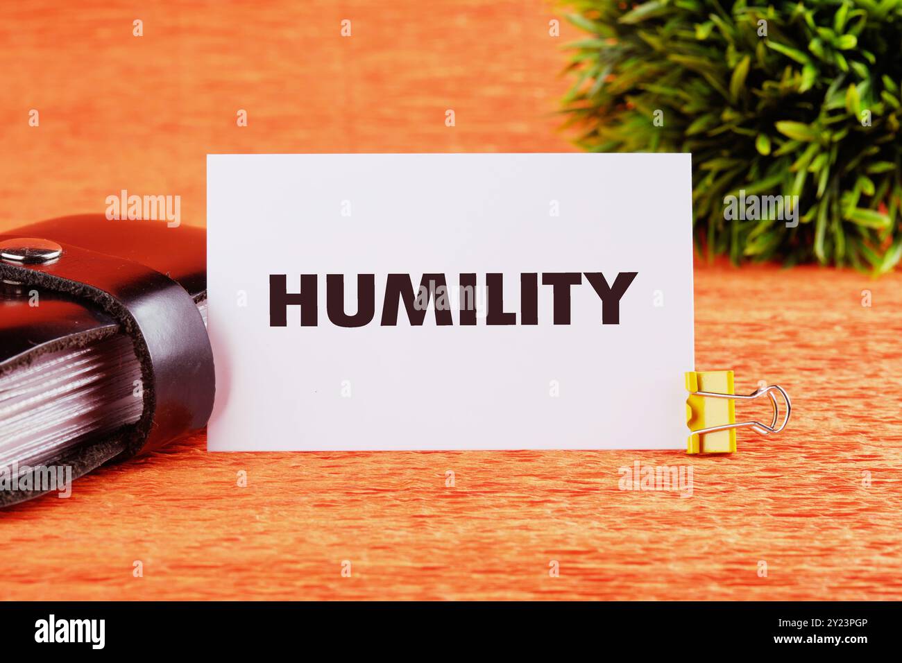 Lifestyle concept. HUMILITY word on a white card on an orange ...