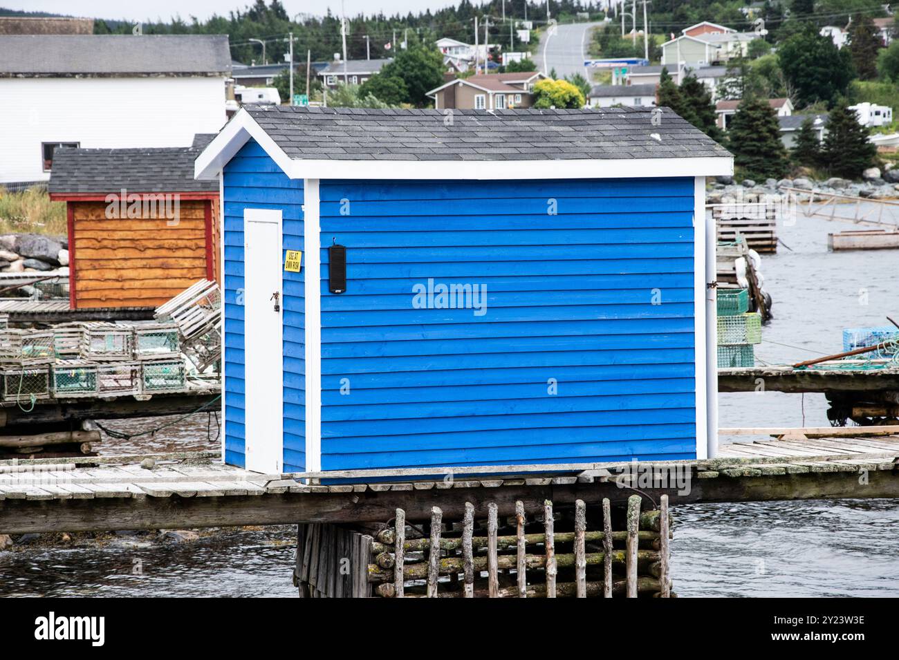 Blue fishing shed and lobster traps on a dock in Heart's Content ...