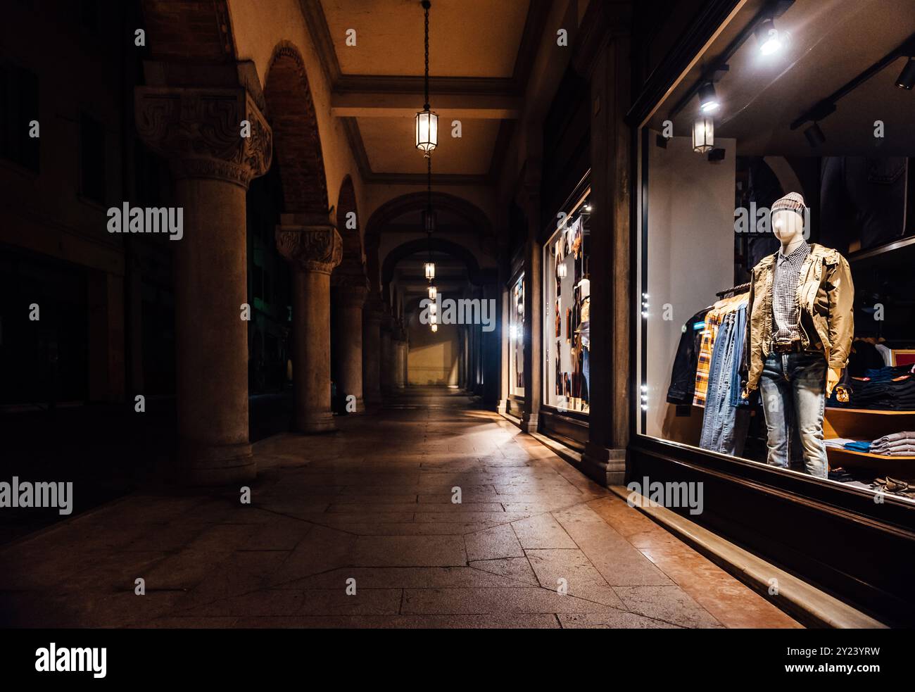 night shop window with clothes in italy Stock Photo - Alamy