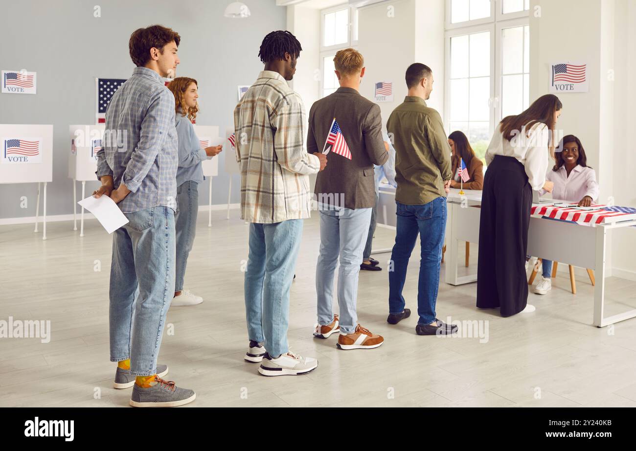 Large diverse group of people registering at polling station holding ...