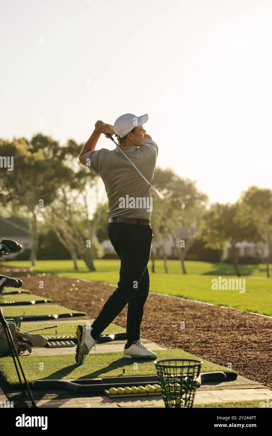 Professional male golfer honing their technique on an early morning ...