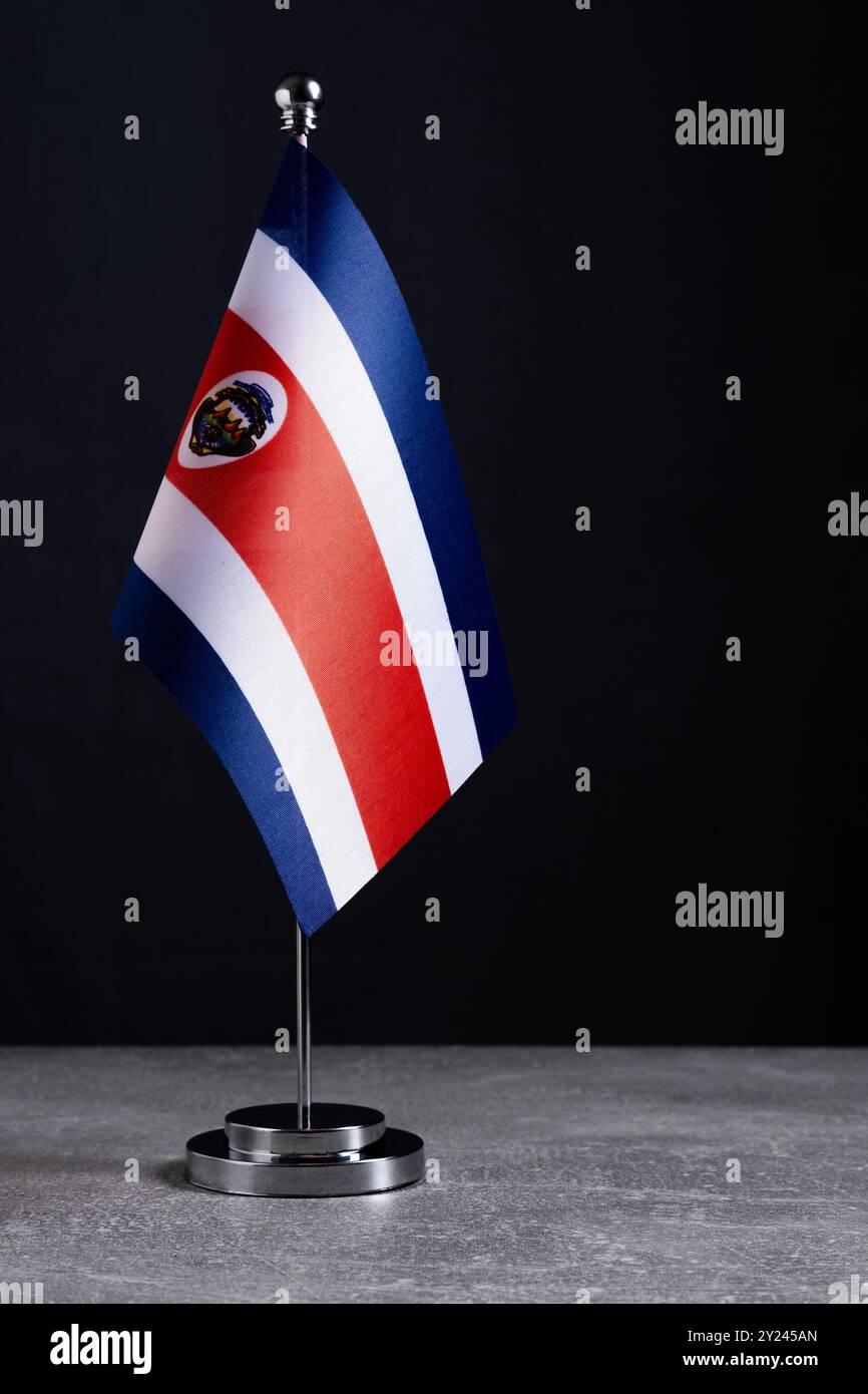 Flag of Costa Rica on stand against black background Stock Photo - Alamy