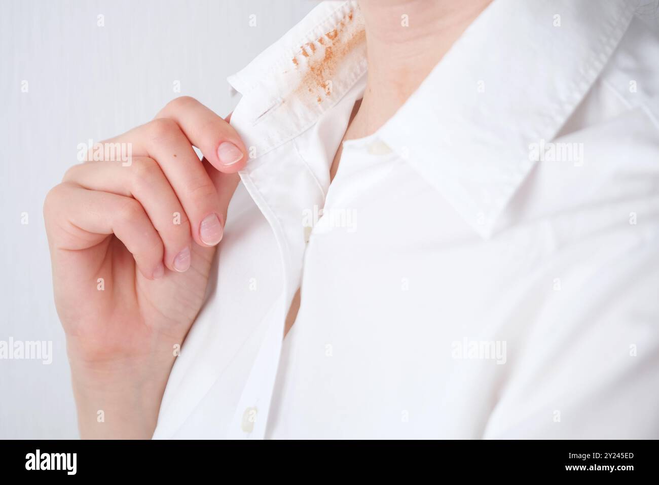 Faceless woman showing a dirty cosmetic stain on the collar of his ...