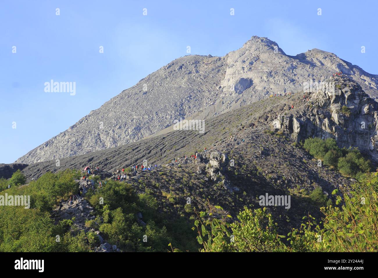 Mass climbing to the summit of Mount Merapi and line of climbers on the ...