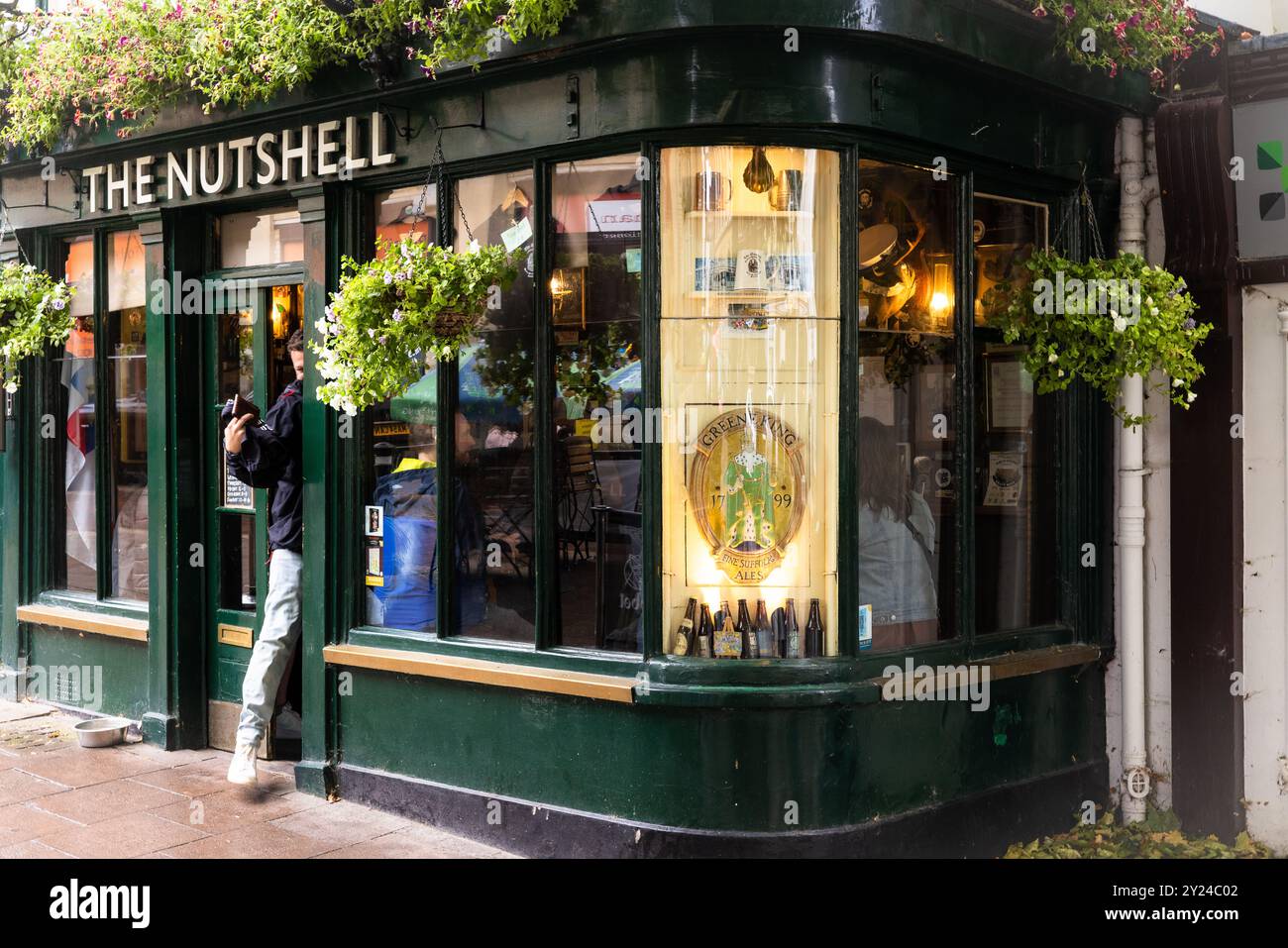 Smallest bar in the United Kingdom called The Nutshell with a person ...