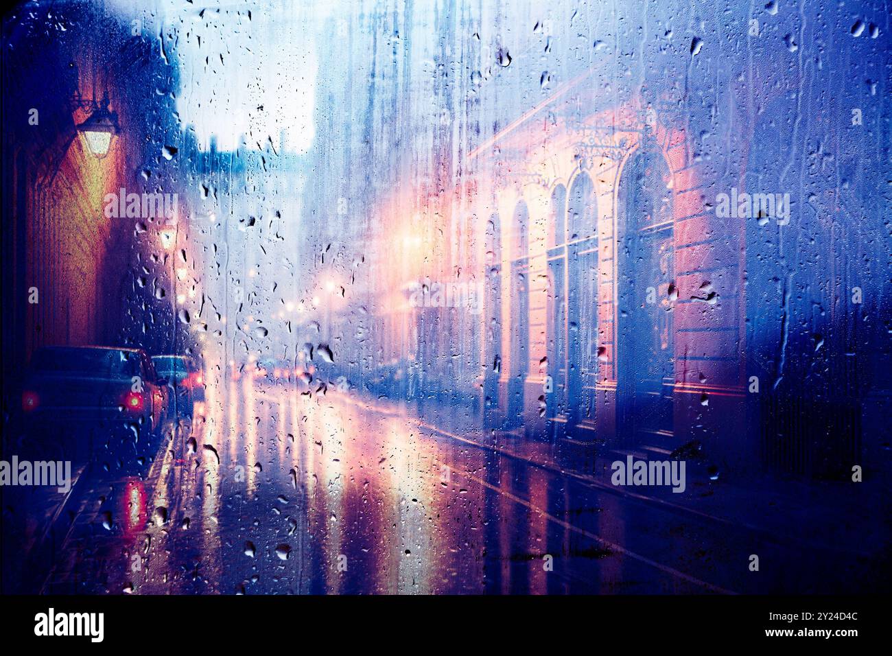 Abstract background of night city street raining through the window ...