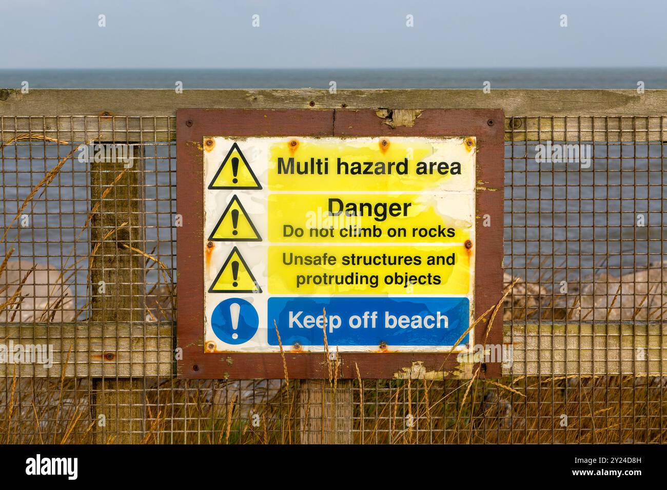 Environment Agency warning danger sign above rock armour, East Lane ...