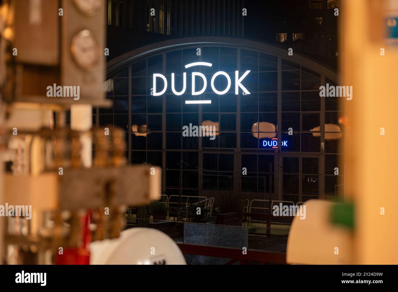 Illuminated logo of Dudok restaurant in Rotterdam near the bridge and river harbour Stock Photo ...