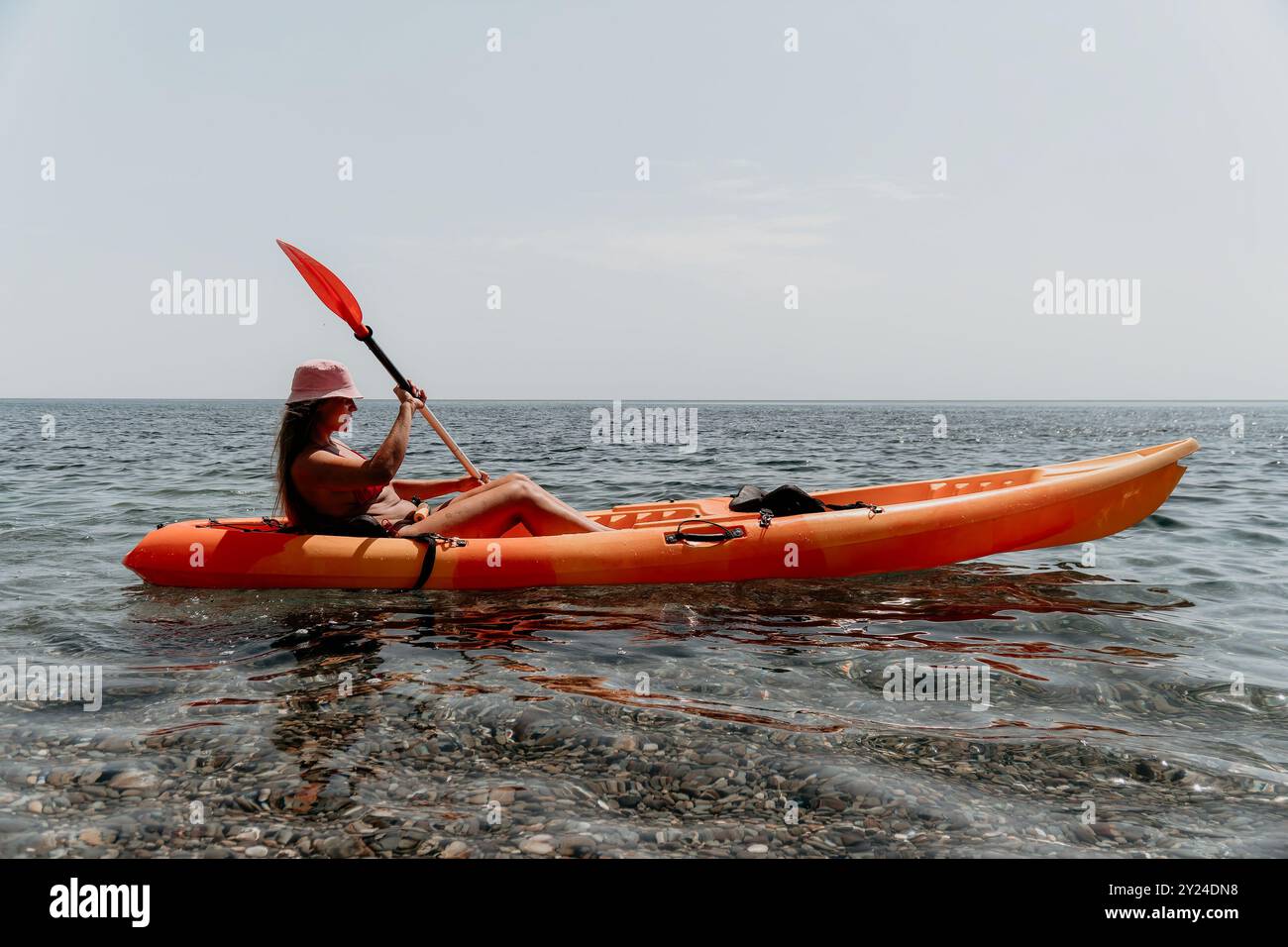 Woman sea kayak. Happy smiling woman paddling in kayak on ocean. Calm ...