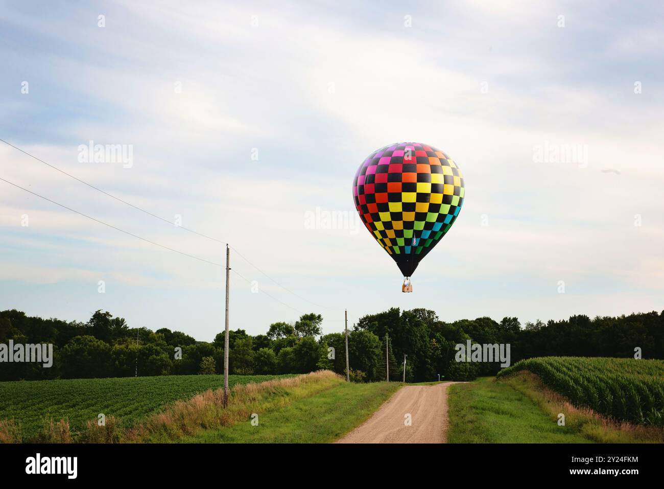 Hot air balloon flying low over a country gravel road Stock Photo - Alamy