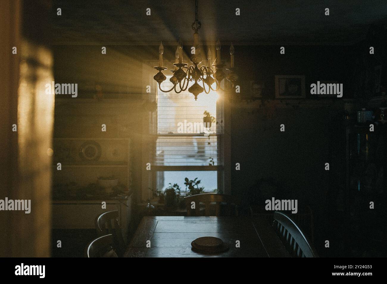 sunbeams through dining room window and chandelier Stock Photo - Alamy