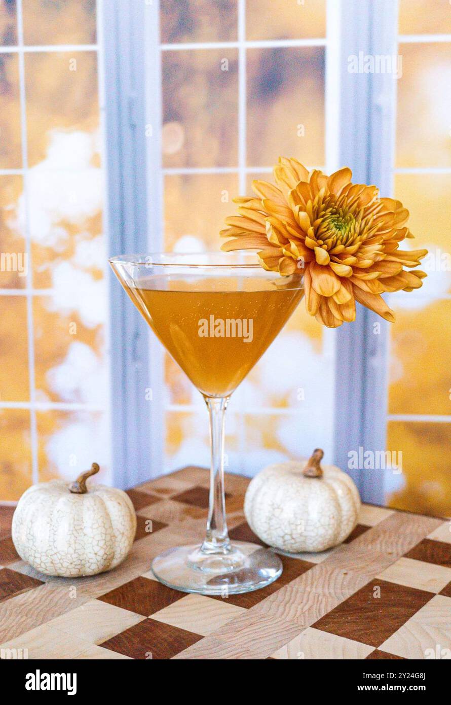 Fall martini with flower garnish Stock Photo - Alamy
