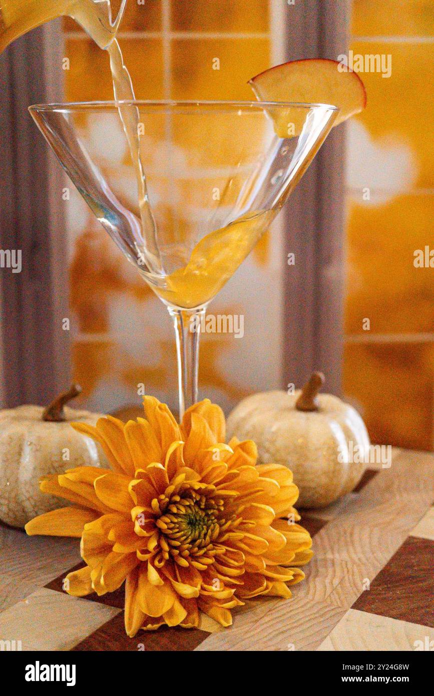 Pitcher pouring liquid into a martini glass Stock Photo - Alamy