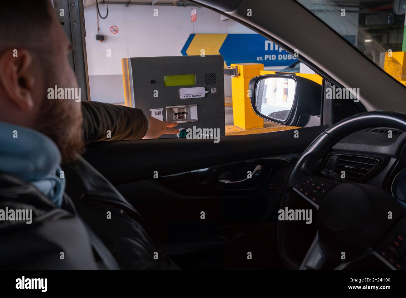 Driver Using Payment Machine at Parking Facility Stock Photo - Alamy