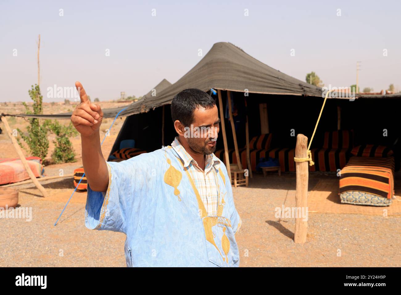 Nomadic camp with dromedaries and camel driver in the desert ...
