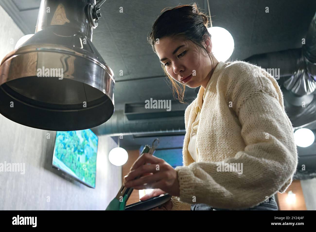 Asian woman cooks meat into the skillet on the stove in the reas Stock ...