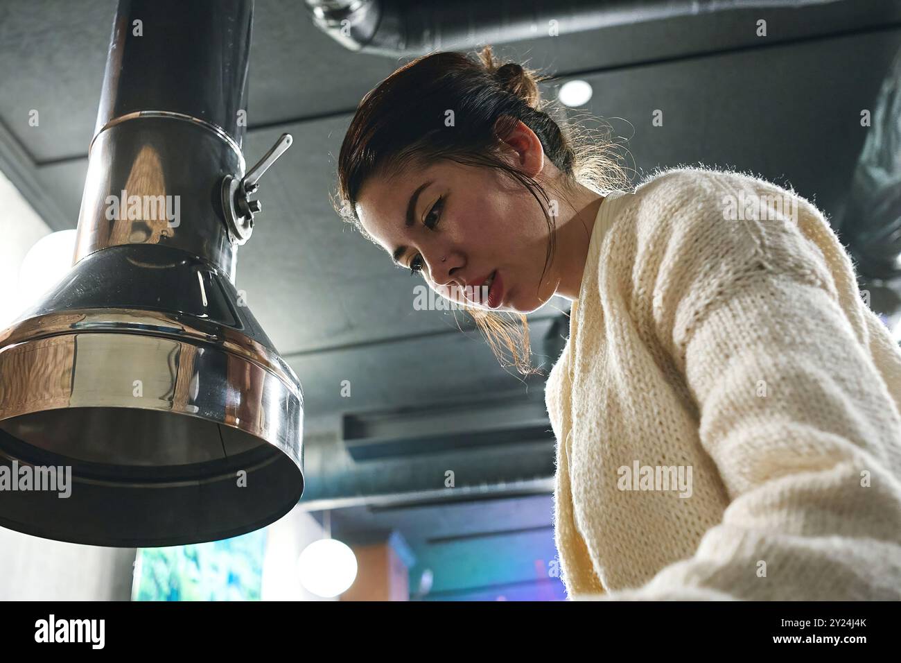 Asian woman cooks meat into the skillet on the stove in the reas Stock ...