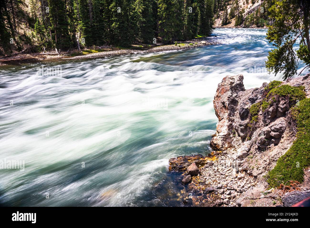 Rushing river in Yellowstone, flowing past rocky banks Stock Photo - Alamy