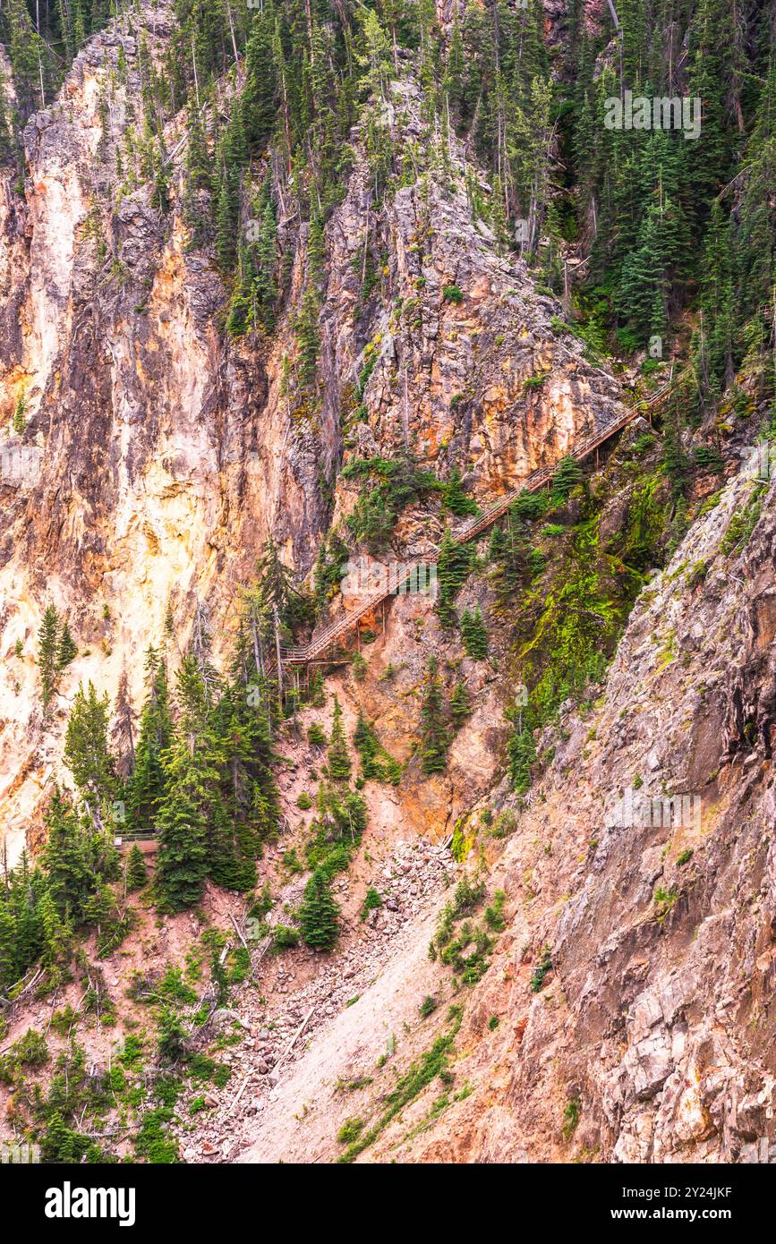 Steep canyon trail with wooden steps climbing through rocky cliffs ...