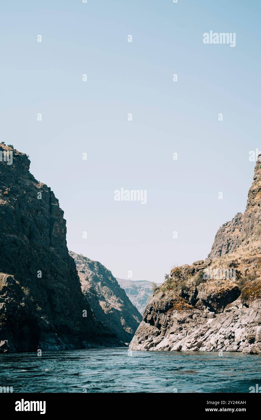 River Flowing Through Dramatic Canyon Cliffs Under a Clear Blue Sky ...