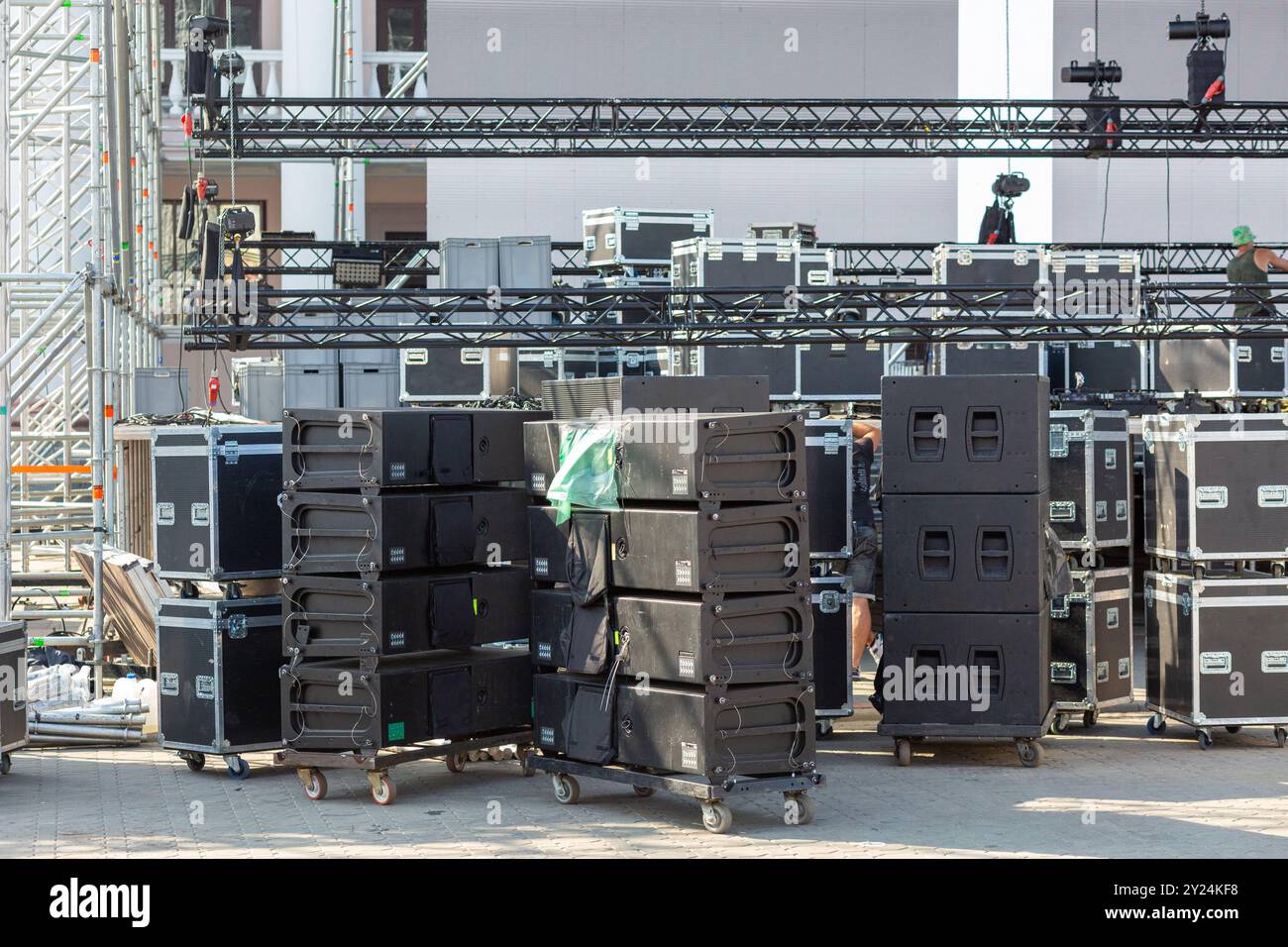 Stacks of sound equipment and lighting gear are arranged at an outdoor ...