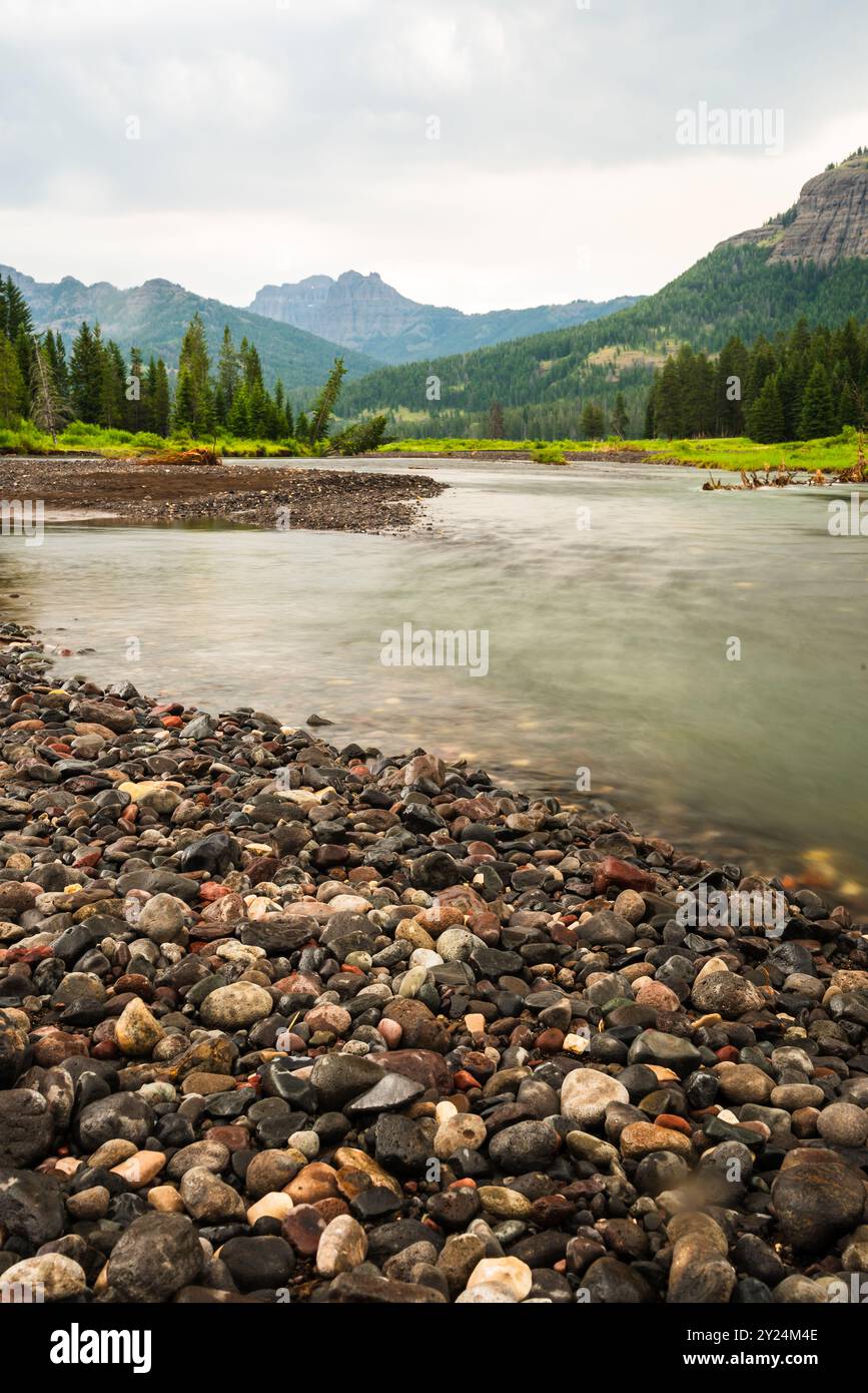 River flows over colorful stones in Yellowstone Stock Photo - Alamy