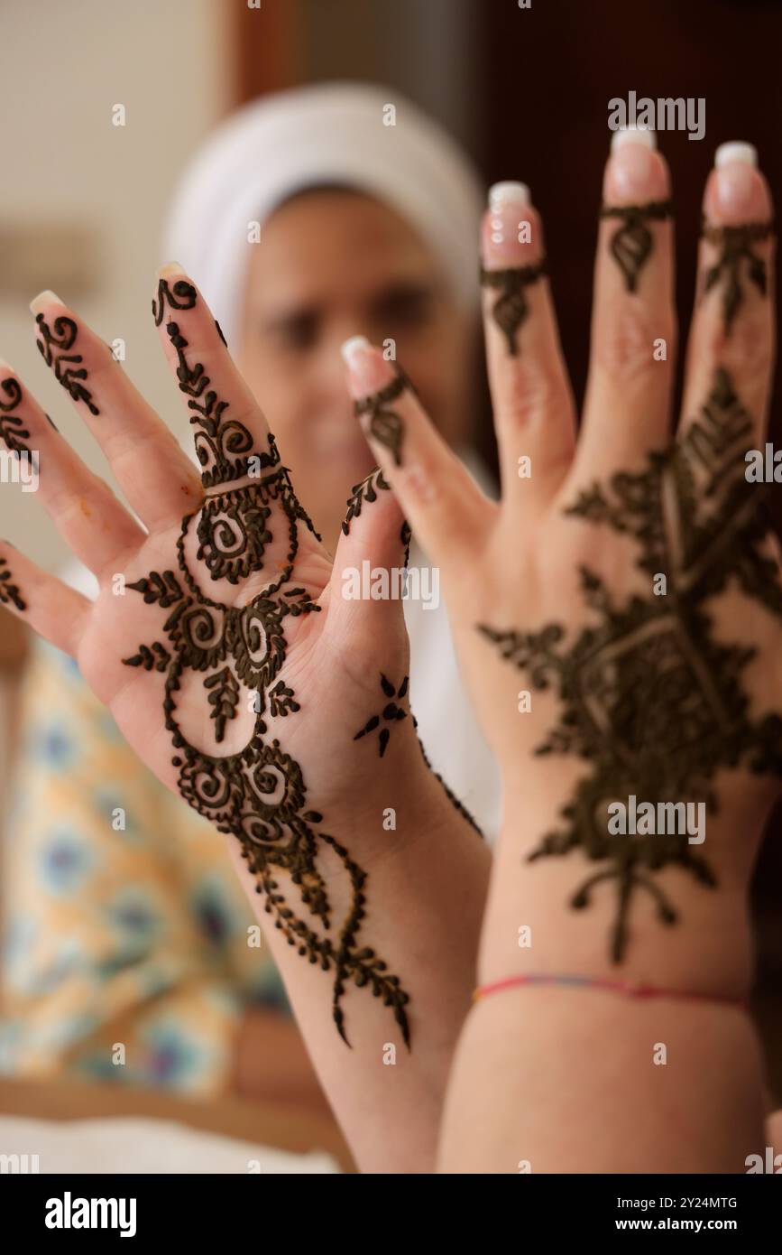 Temporary tattoo of woman's hands with henna in the Marrakech region of ...