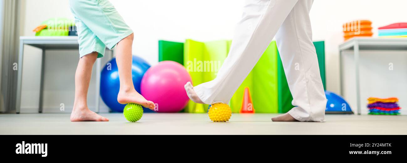 Child and physical therapist during physical therapy session. Kid ...