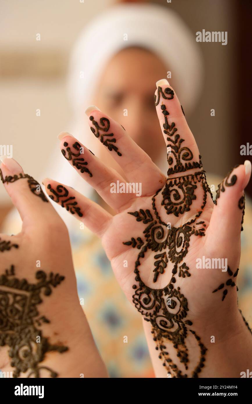 Temporary tattoo of woman's hands with henna in the Marrakech region of ...