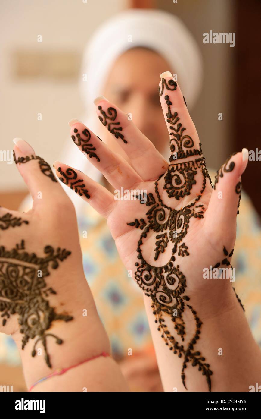 Temporary tattoo of woman's hands with henna in the Marrakech region of ...