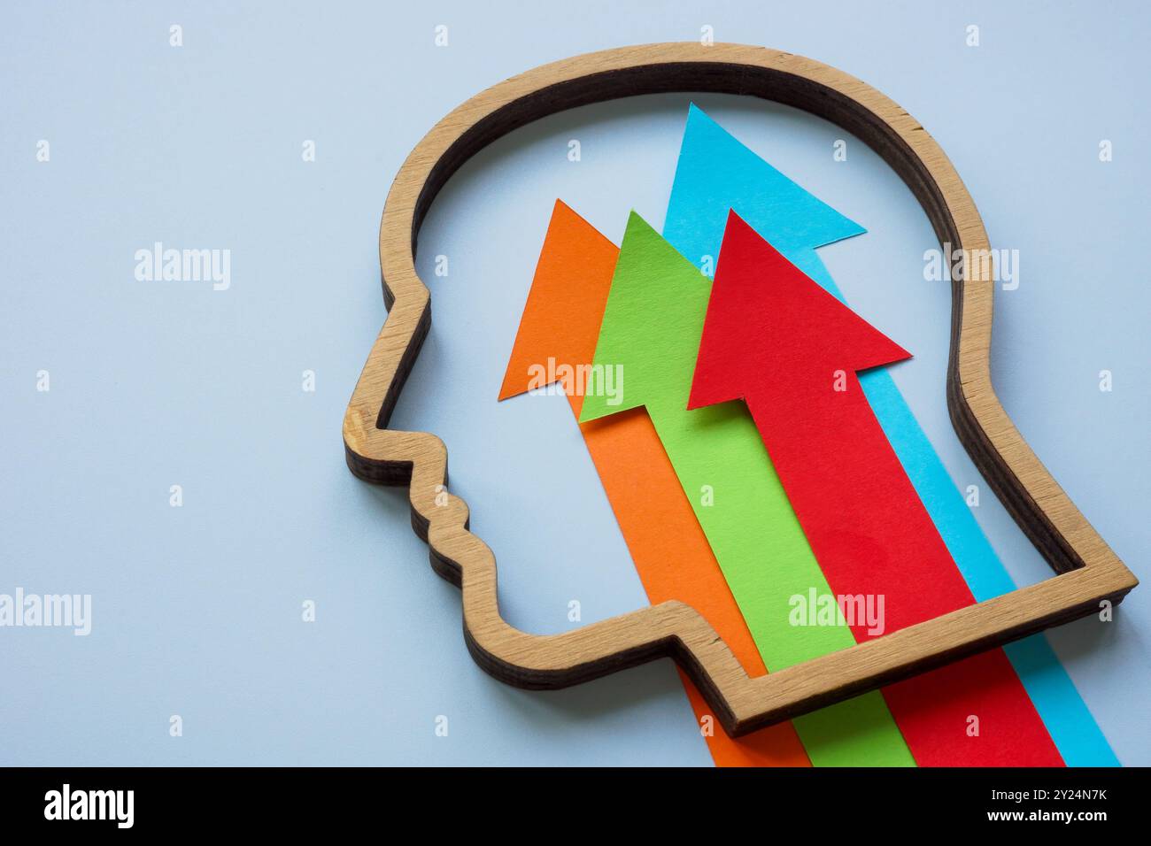 Outline of a head with growing arrows inside. Personal development or ...