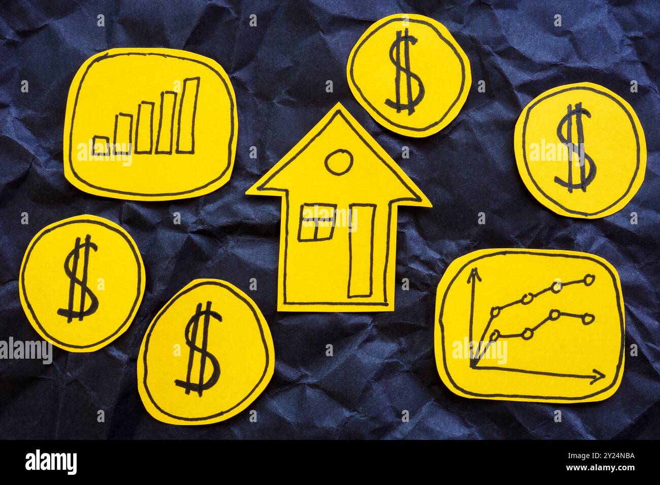Paper house and financial charts as symbol of real estate investment ...