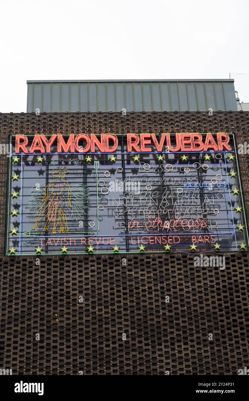 Large illuminated neon sign on wall outside the former Raymond Revue ...