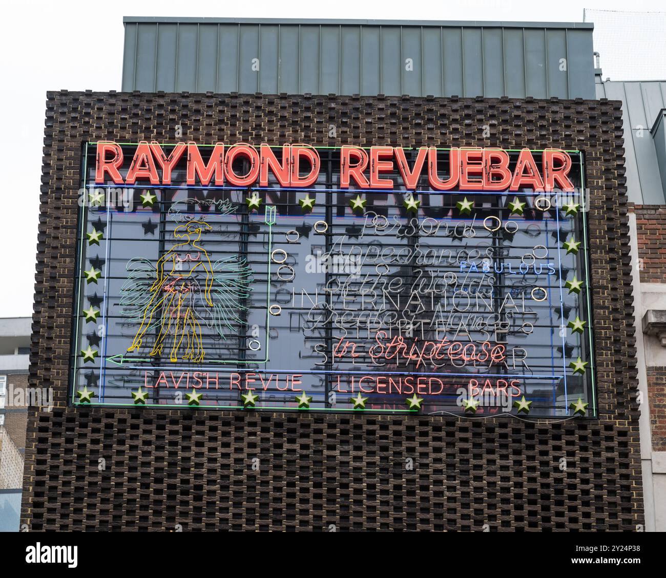 Large illuminated neon sign on wall outside the former Raymond Revue ...