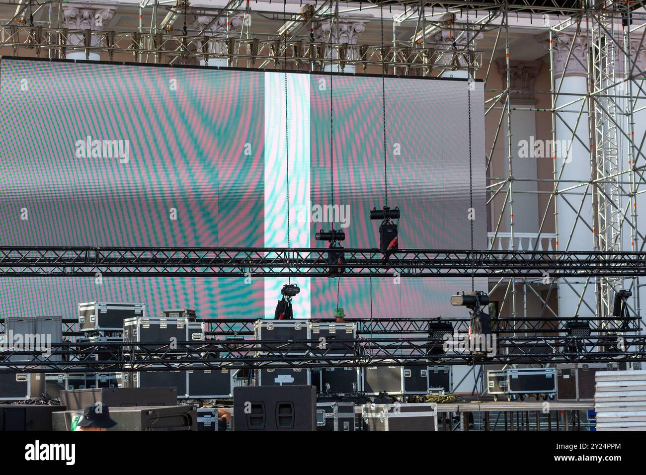 Stacks of sound equipment and lighting gear are arranged at an outdoor ...