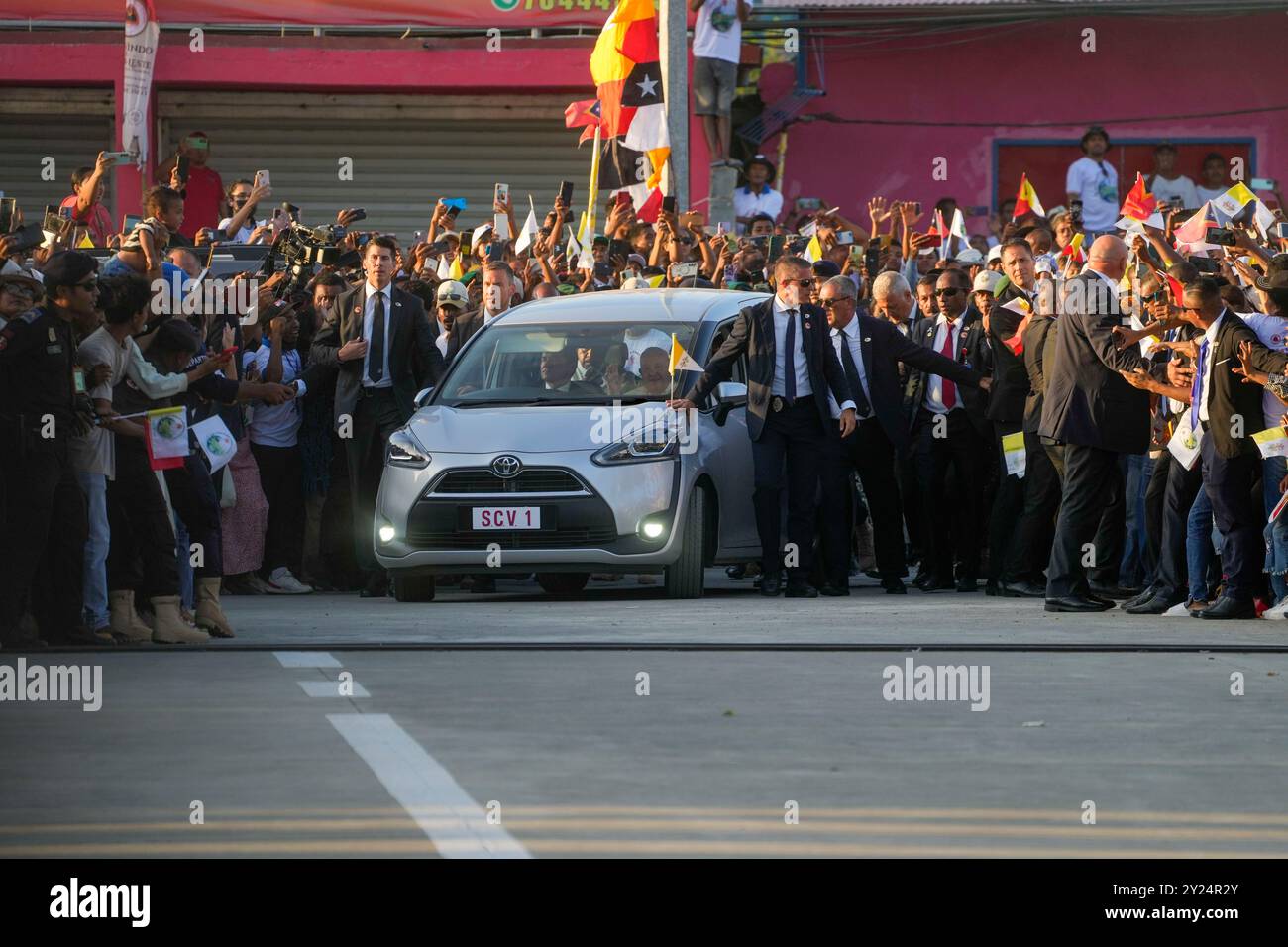 Pope Francis waves from his car as he arrives at the Presidential ...