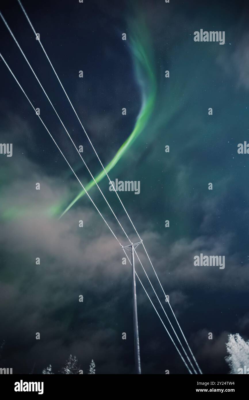 Strong northern lights above snowy power lines in Rovaniemi, Lapland ...